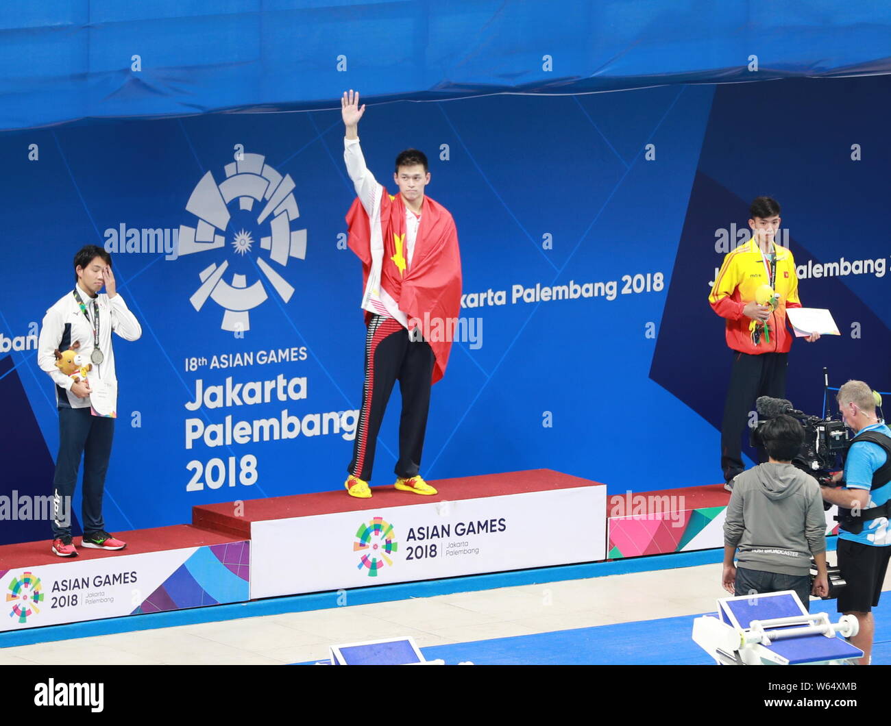 Gold medalist Sun Yang of China waves during the medal ceremony of the ...