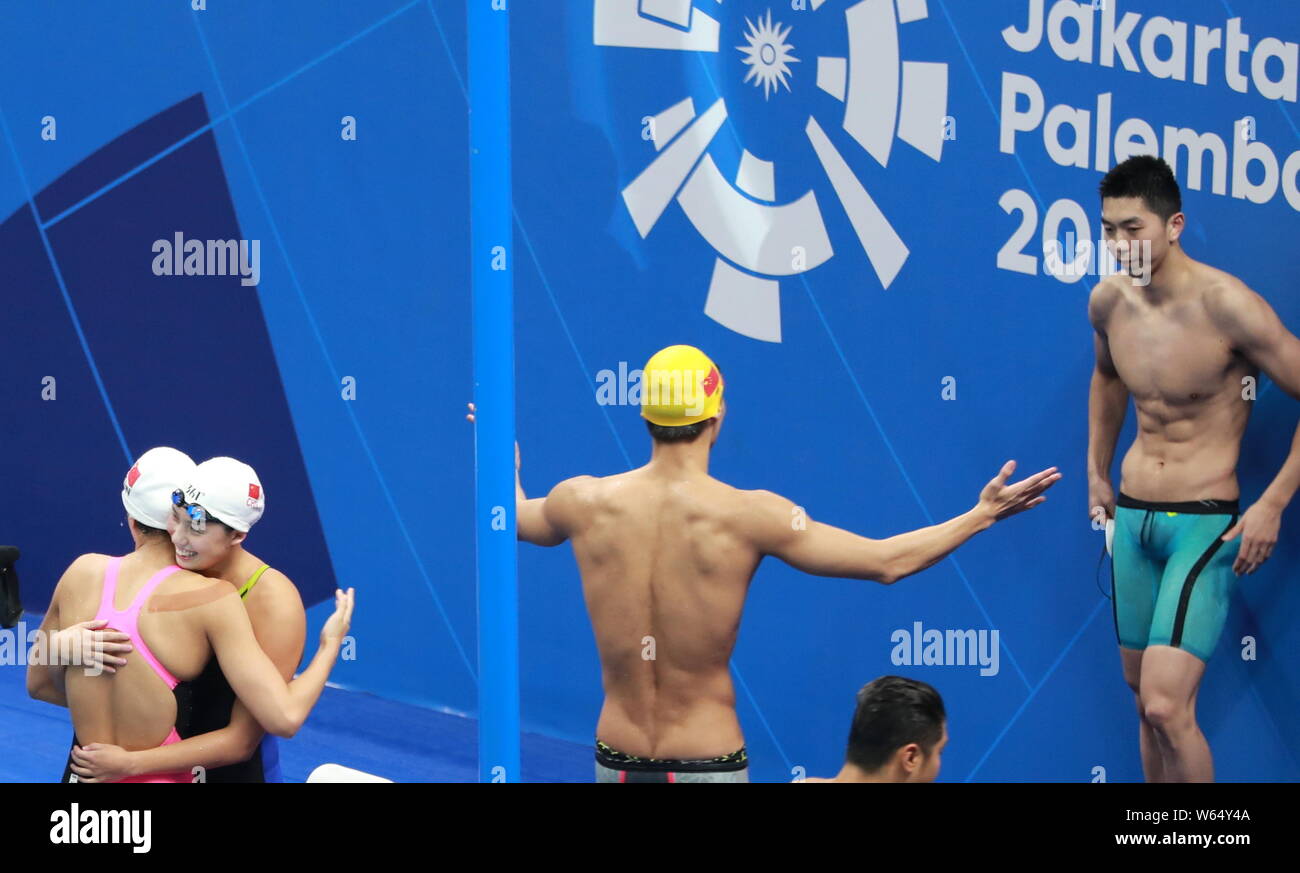 China's mixed 4x100 medley relay team celebrates after winning the ...
