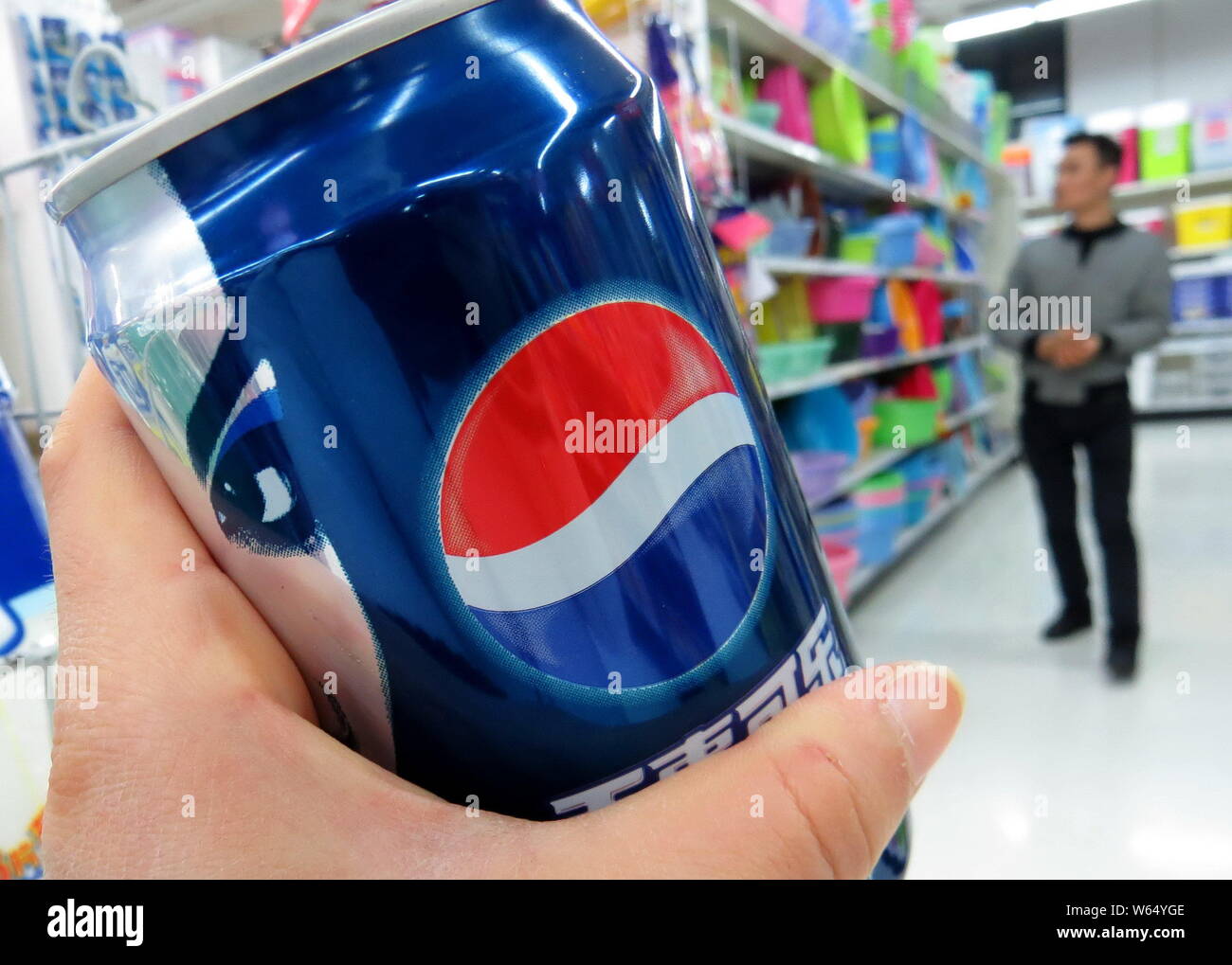 --FILE--A customer shops for a can of Pepsi Cola at a supermarket in ...