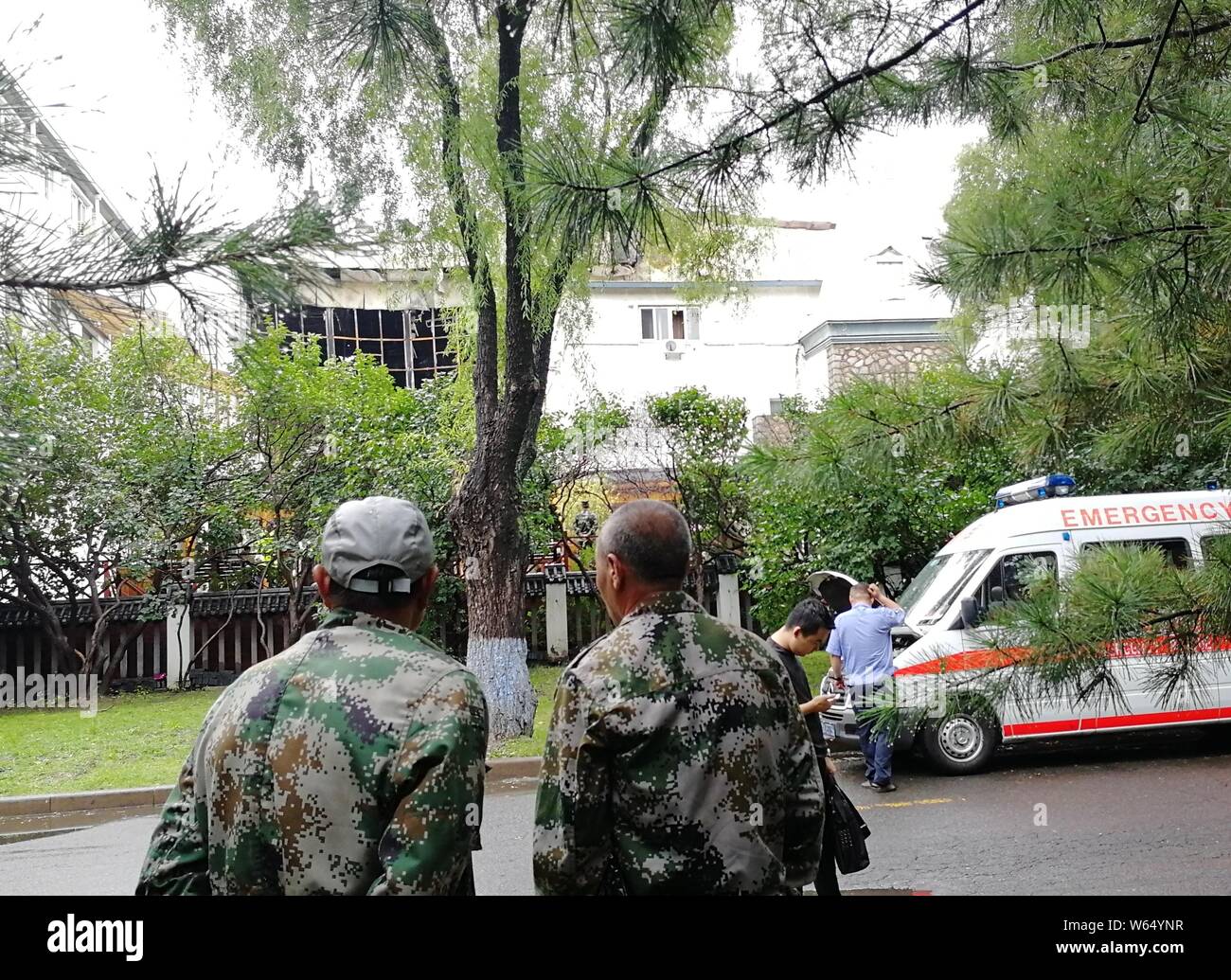 Soldiers are pictured at the accident site after a spa hotel caught ...
