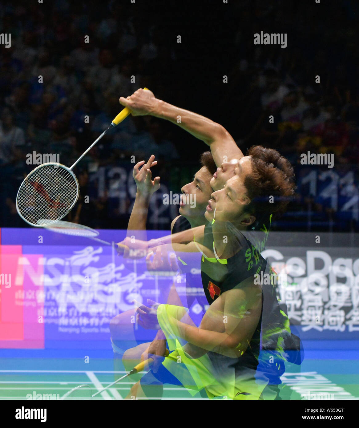 Shi Yuqi of China returns a shot to Chen Long of China in their men's singles semifinal match ...