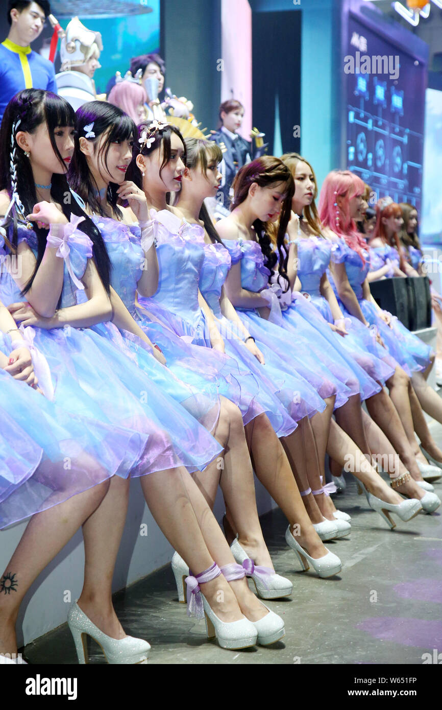 Chinese showgirls pose at the stand of Shanda Games during the 16th ...