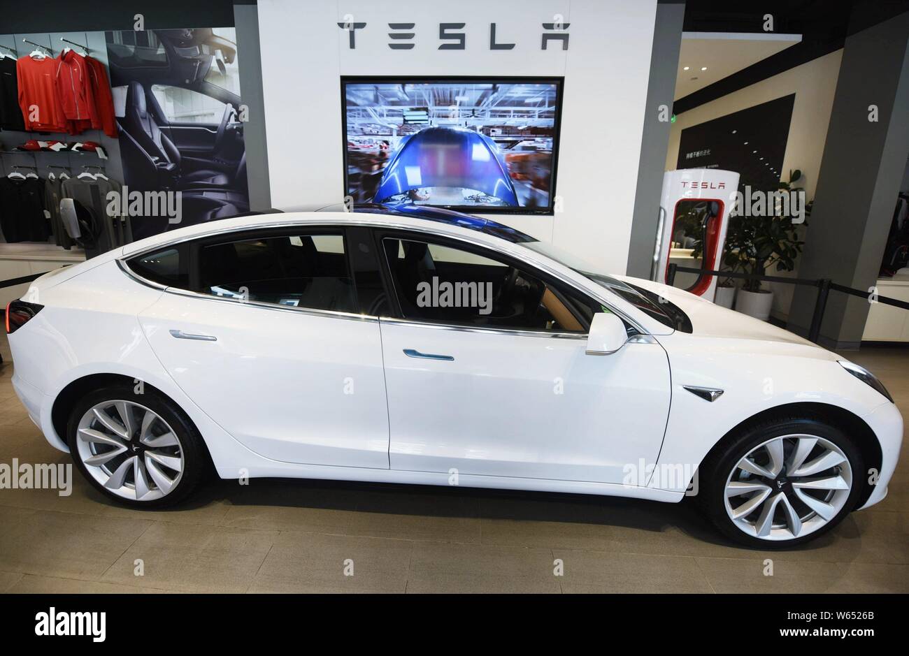 --FILE--A Tesla Model 3 electric car is on display at a Tesla ...