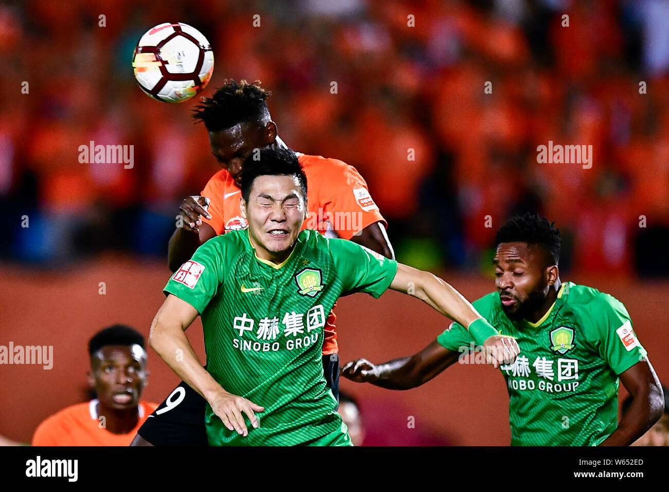 Senegalese football player Makhete Diop, top, of Beijing Renhe heads ...