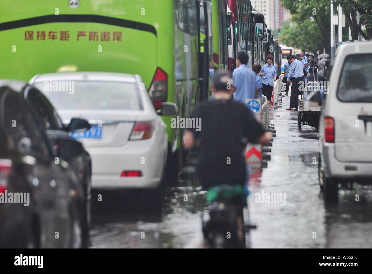 Cars get stuck on a flooded road caused by heavy rainstorm in a traffic ...