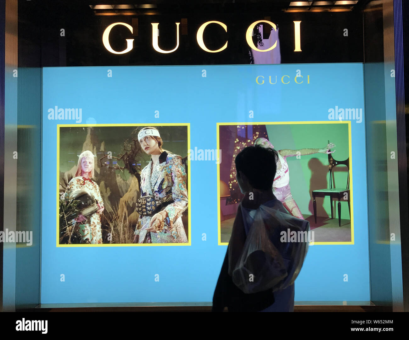 --FILE--A pedestrian walks past a signboard of Gucci in Shanghai, China ...
