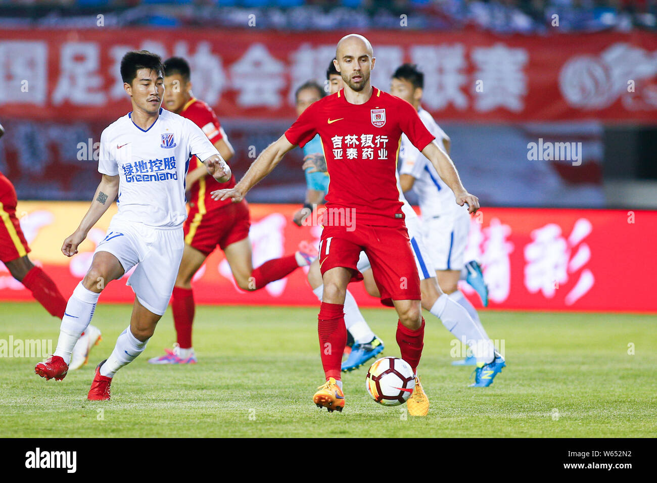 Polish football player Adrian Mierzejewski, right, of Changchun Yatai ...