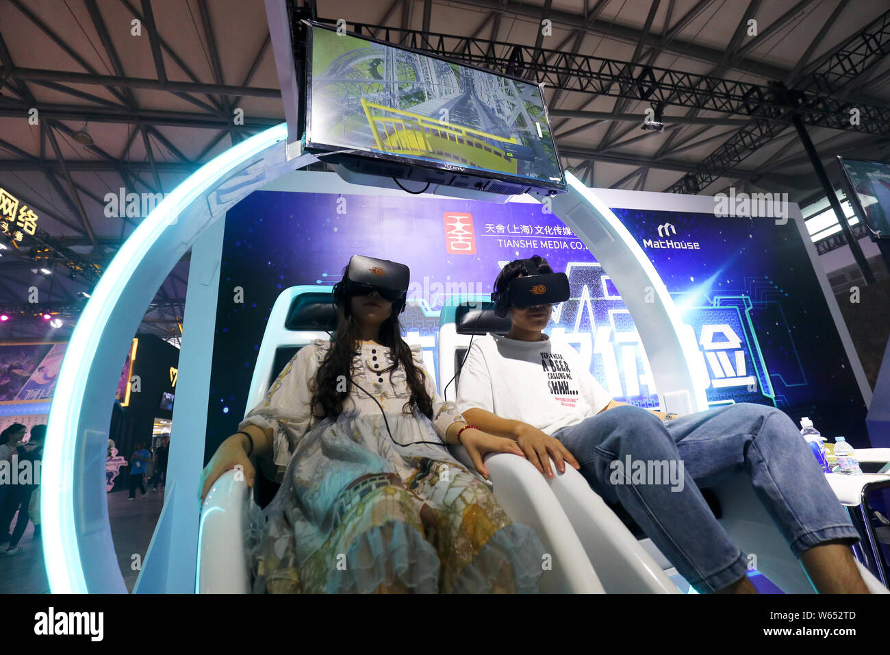 Chinese visitors try out a VR console during the 16th China Digital ...