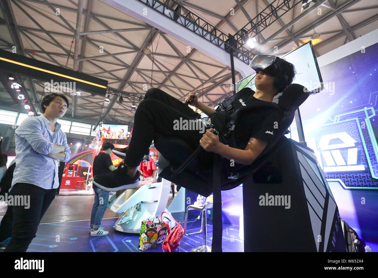 A Chinese visitor tries out a VR console during the 16th China Digital ...