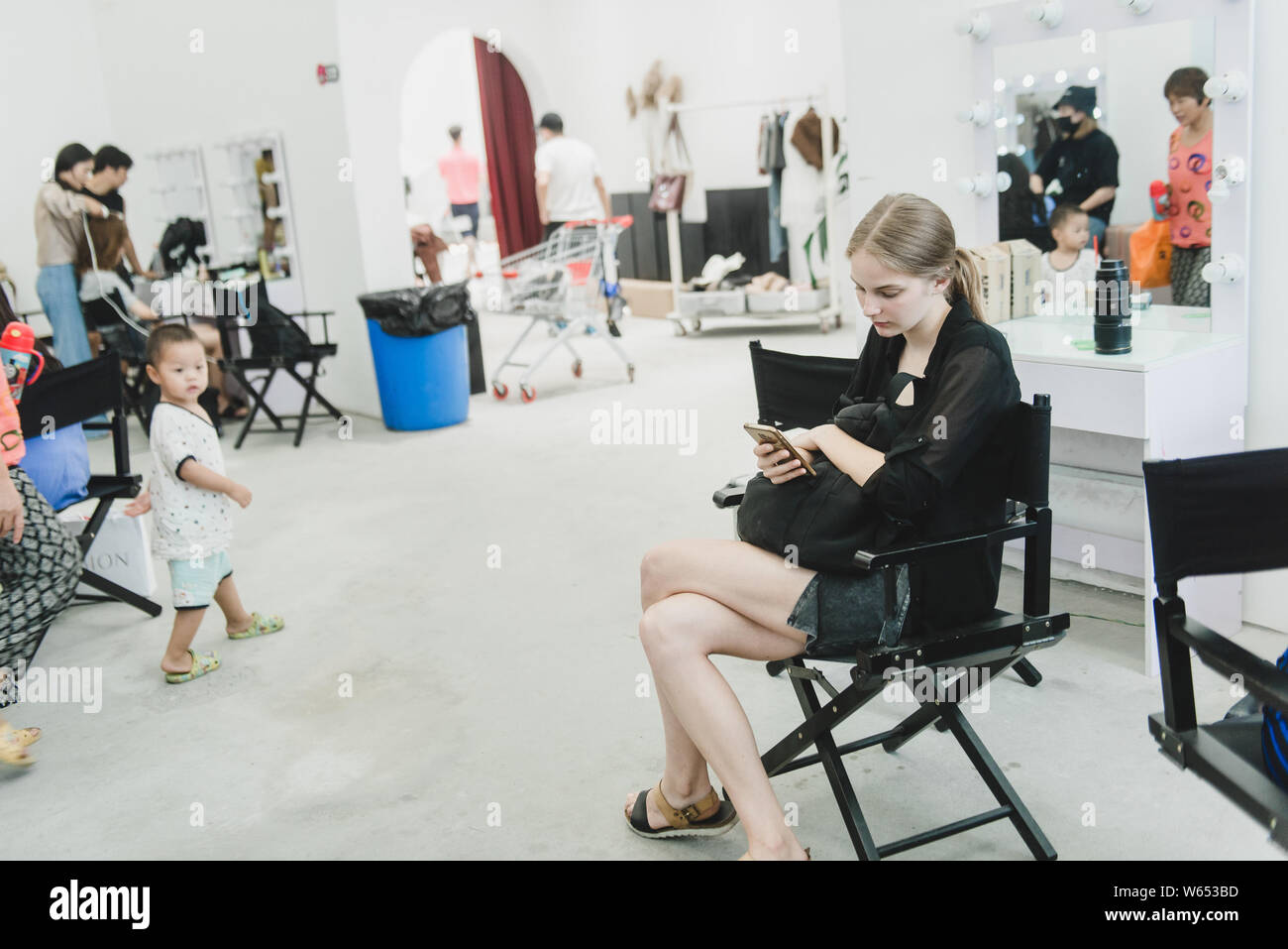 A foreign model from Czech Republic waits for her turn for makeup as ...