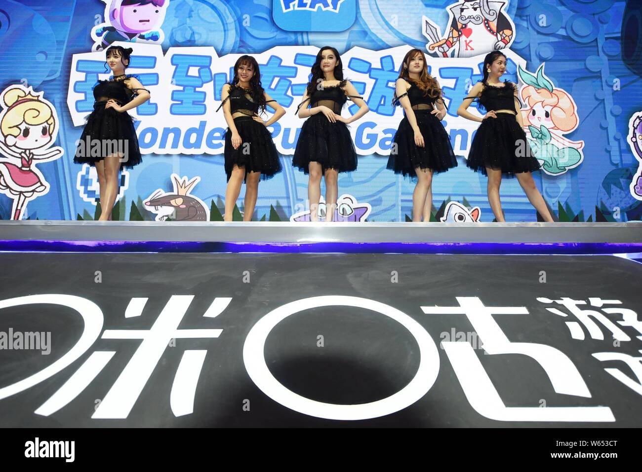 Chinese showgirls pose at the stand of Migu Games during the 16th China ...
