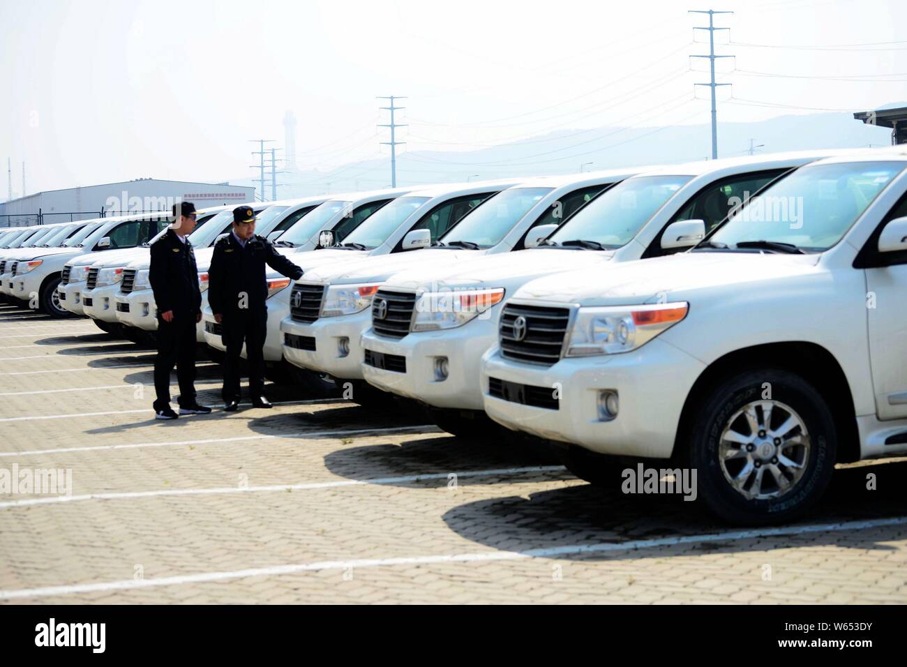 --FILE--Chinese customs officers check imported cars on a quay at the ...