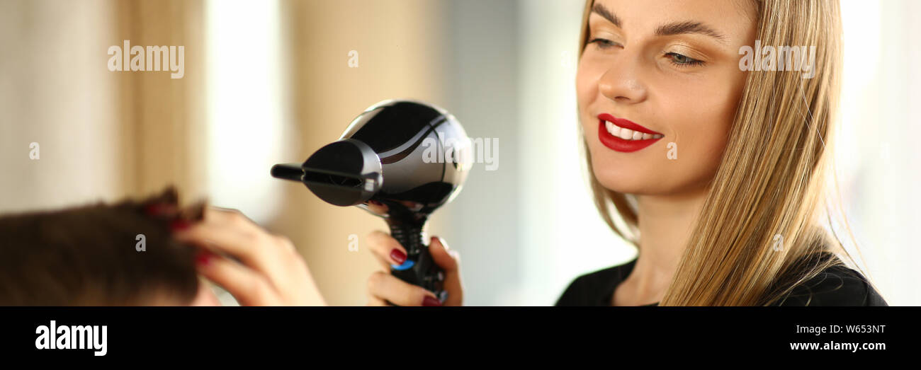 Woman Hairdresser Drying Male Hair with Hairdryer Stock Photo - Alamy