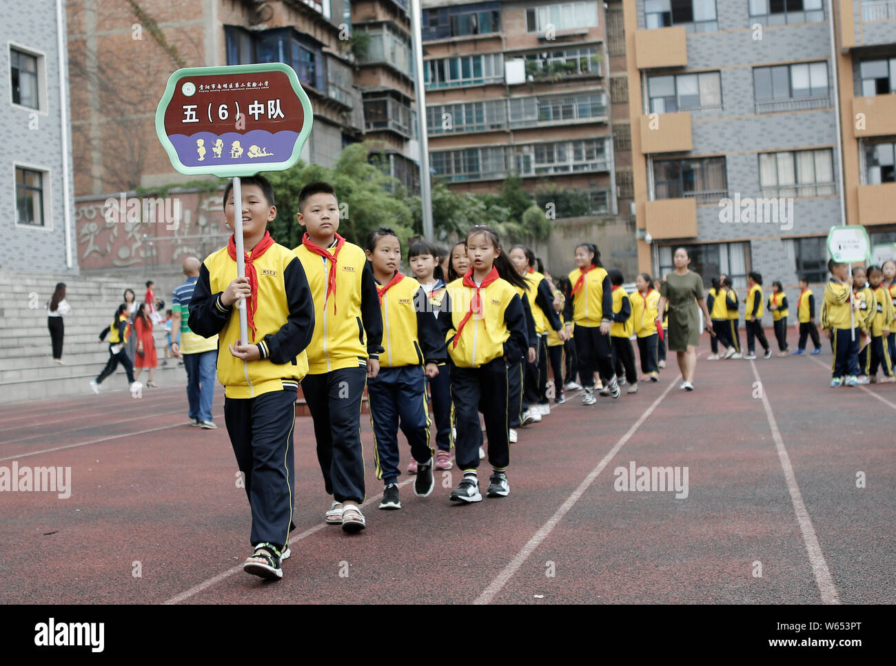 Students attend a flag-raising ceremony of a new semester at a primary ...