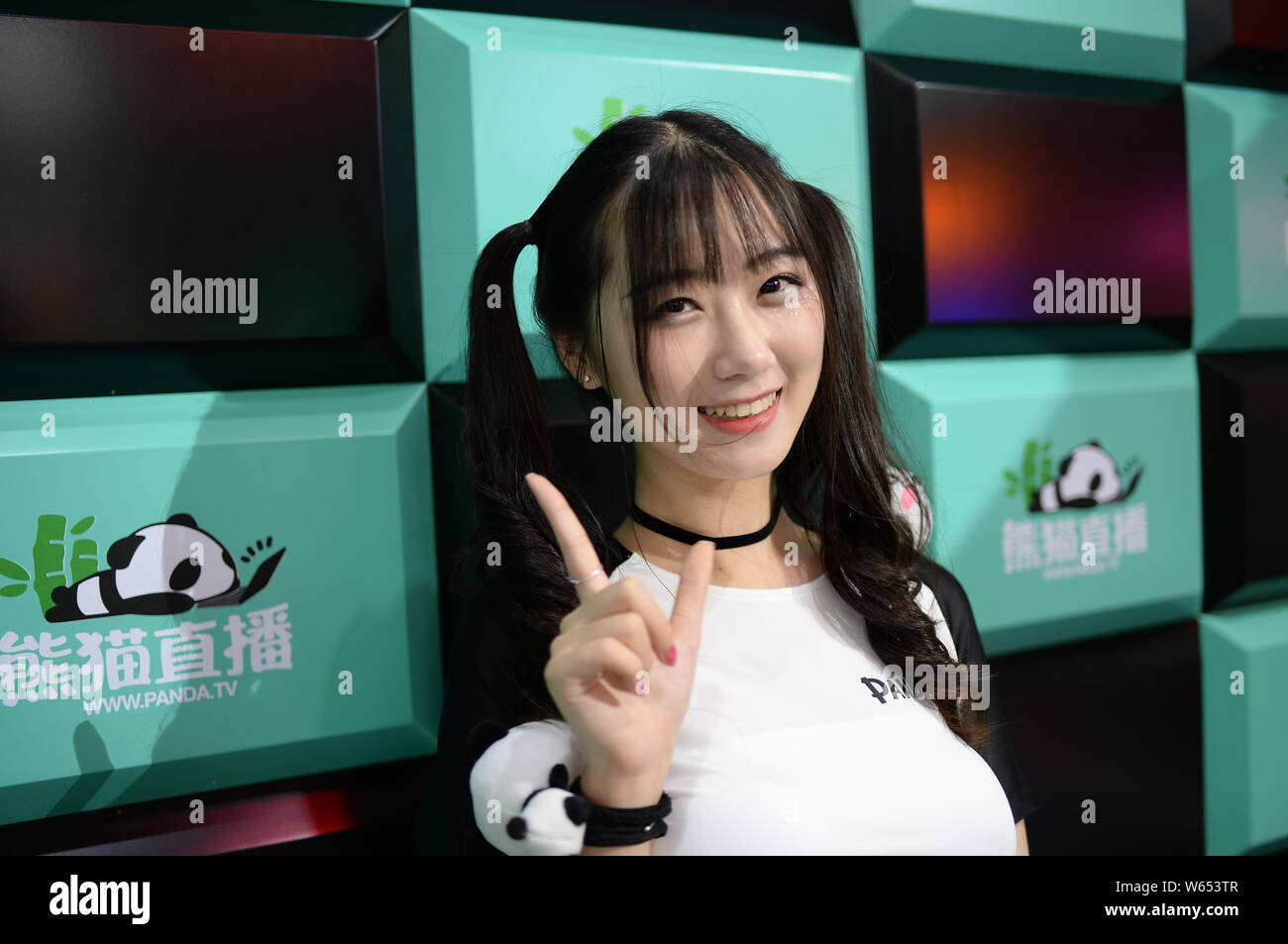 A Chinese Showgirl Poses At The Stand Of Chinese Mobile Video Live Streaming Platform Panda Tv