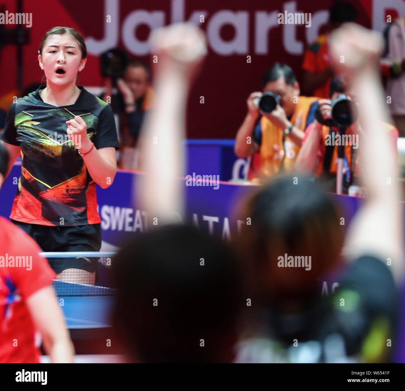 Chen Meng of China, back, celebrates with her teammates after defeating ...