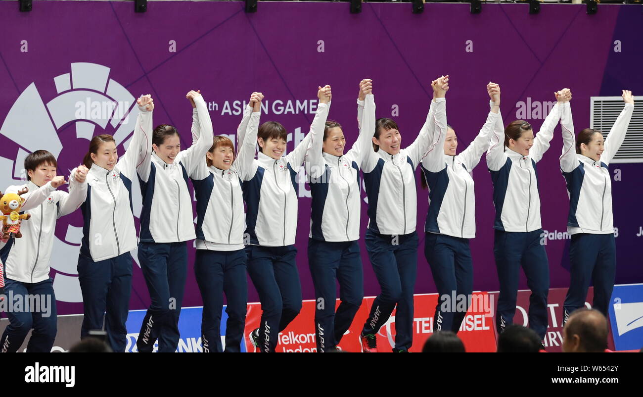 Gold medalist Japan's women's badminton team pose at the award ceremony ...