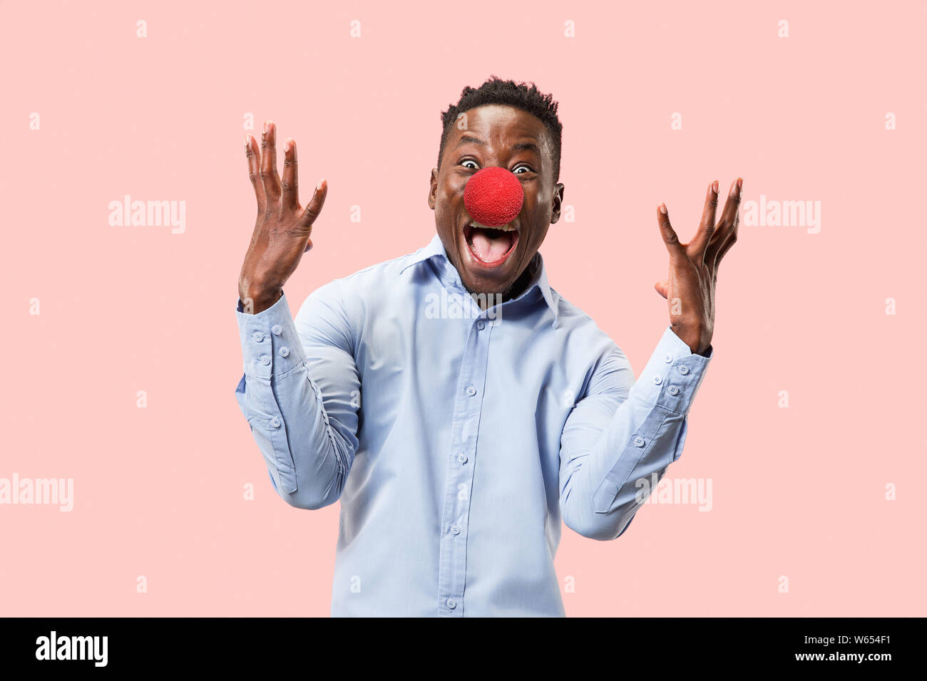 Portrait of young happy man celebrating red nose day. African male ...