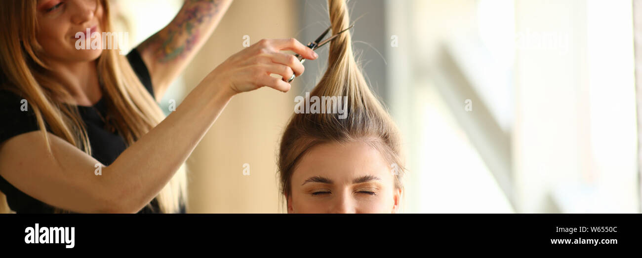 Tattooed Stylist Cutting Hair of Closed Eyes Woman Stock Photo - Alamy