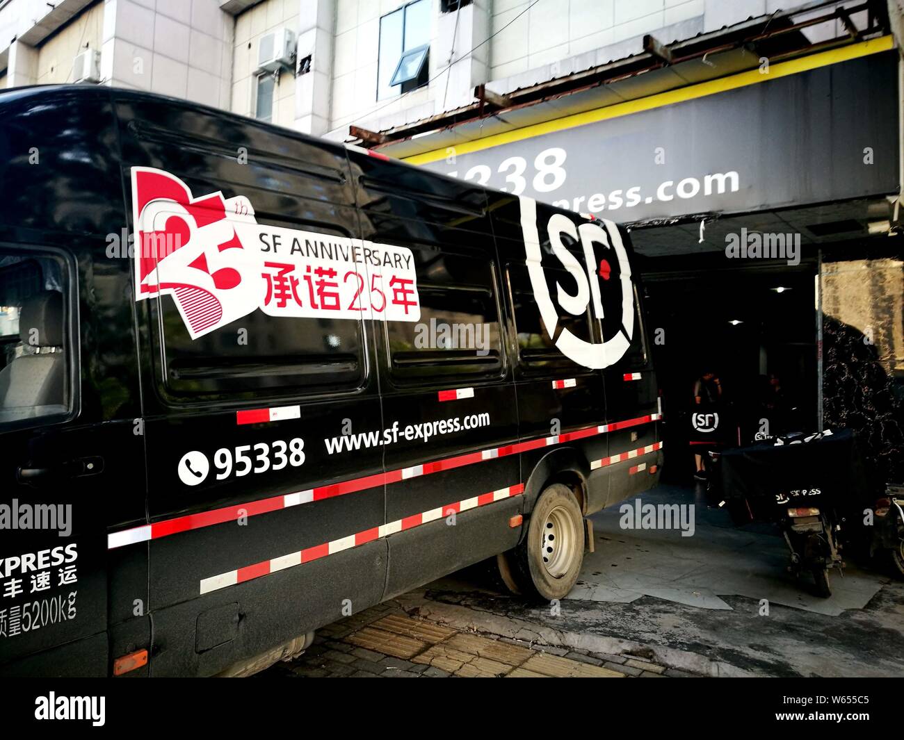 --FILE--A delivery truck of SF Express is parked in front of a ...