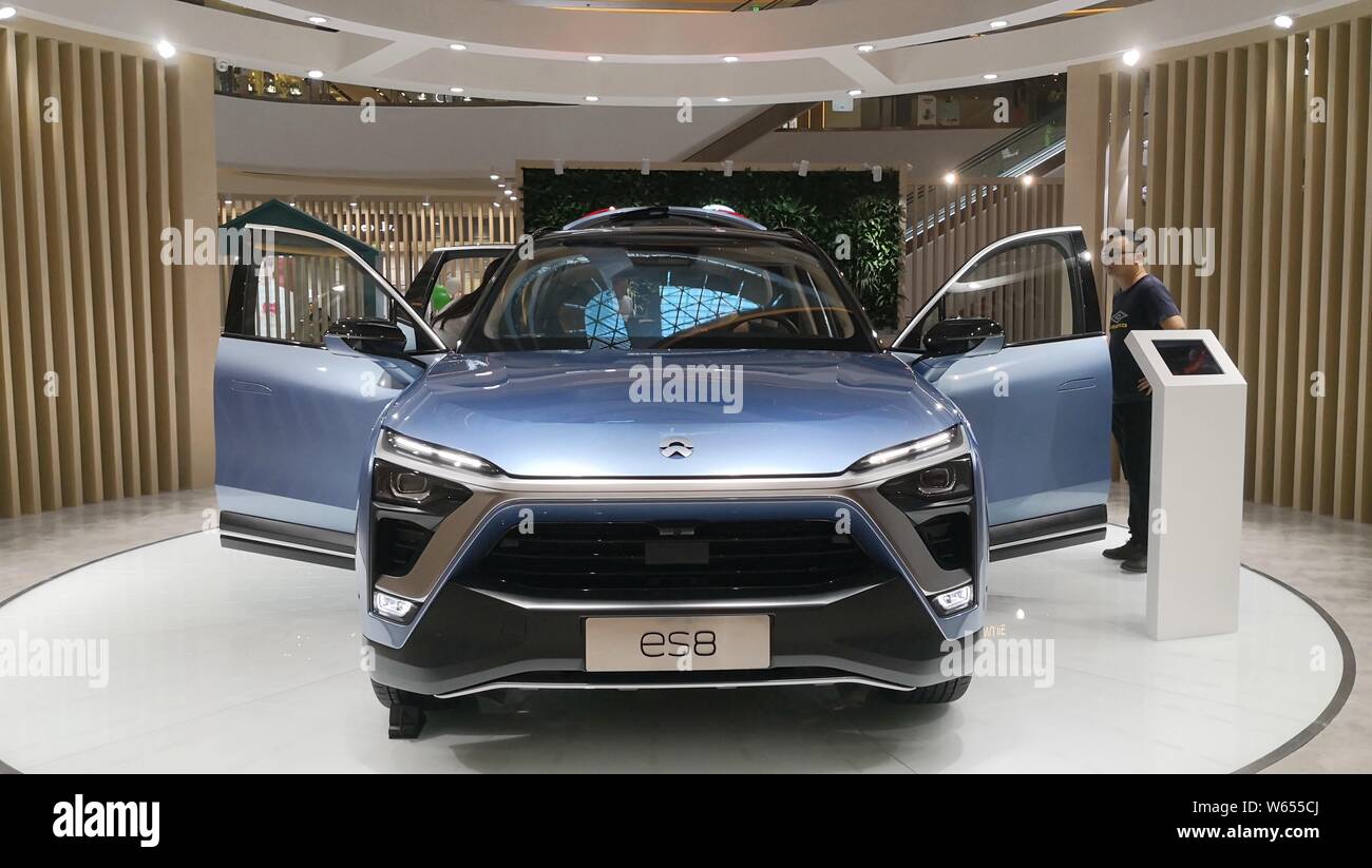 --FILE--Visitors view a NIO ES8 electric SUV on display at a showroom ...