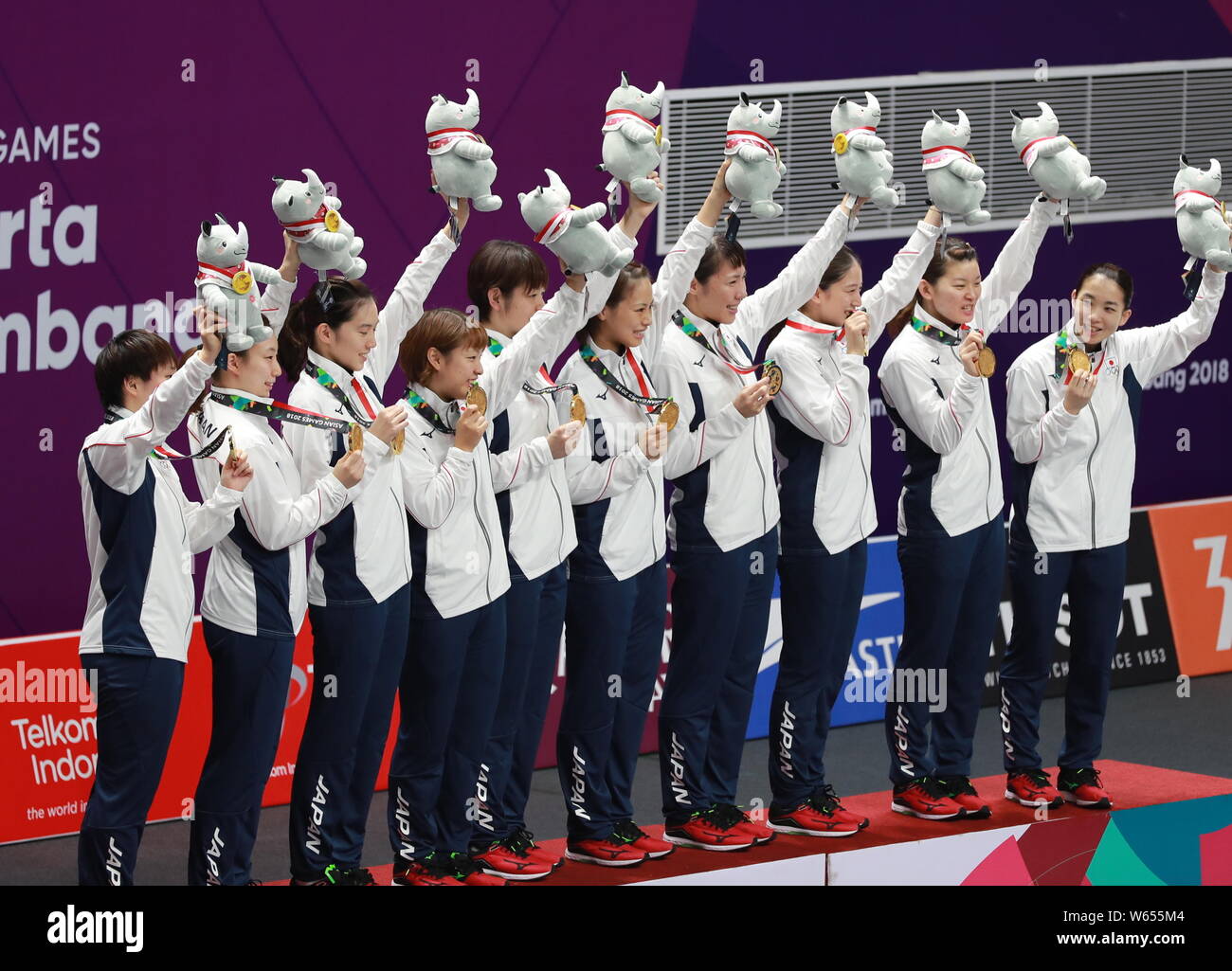 Gold medalist Japan's women's badminton team pose at the award ceremony ...