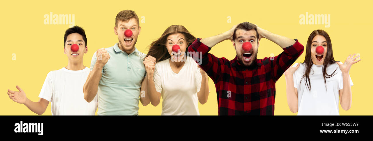 Beautiful young people celebrating red nose day isolated on yellow ...