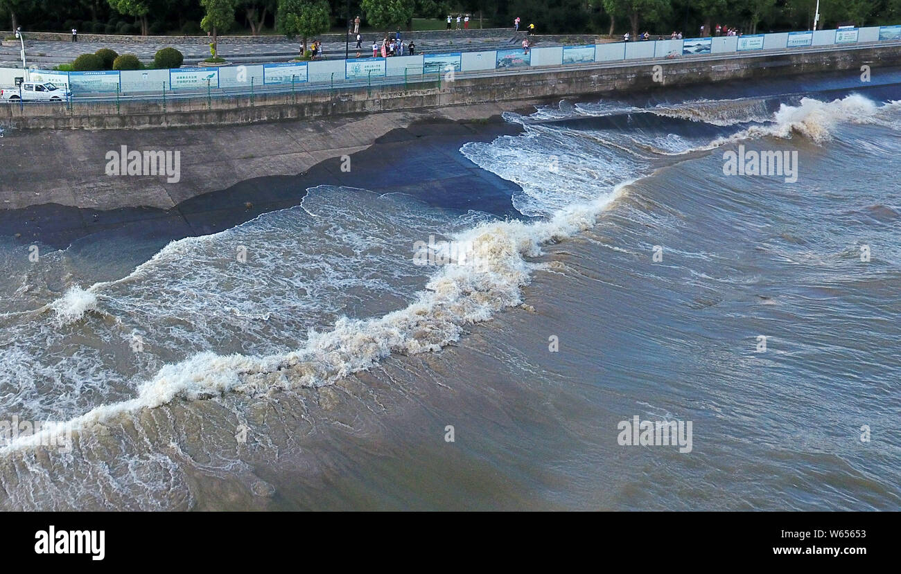 Tidal waves surge the bank of the Qiantang River in Hangzhou city, east ...