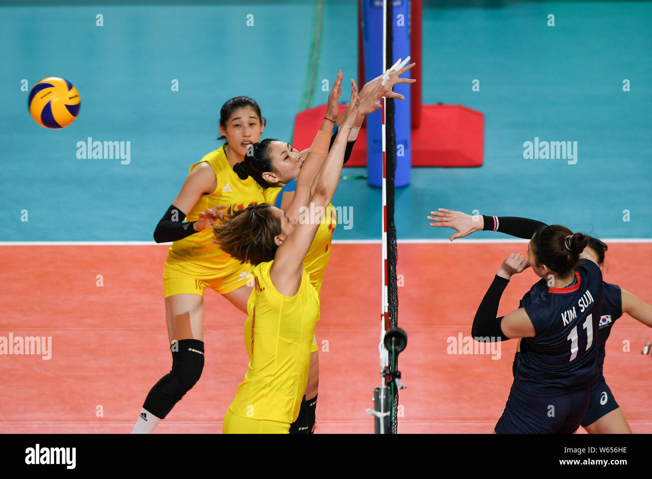 Kim Su-ji of South Korea, right, spikes against players of China in the ...