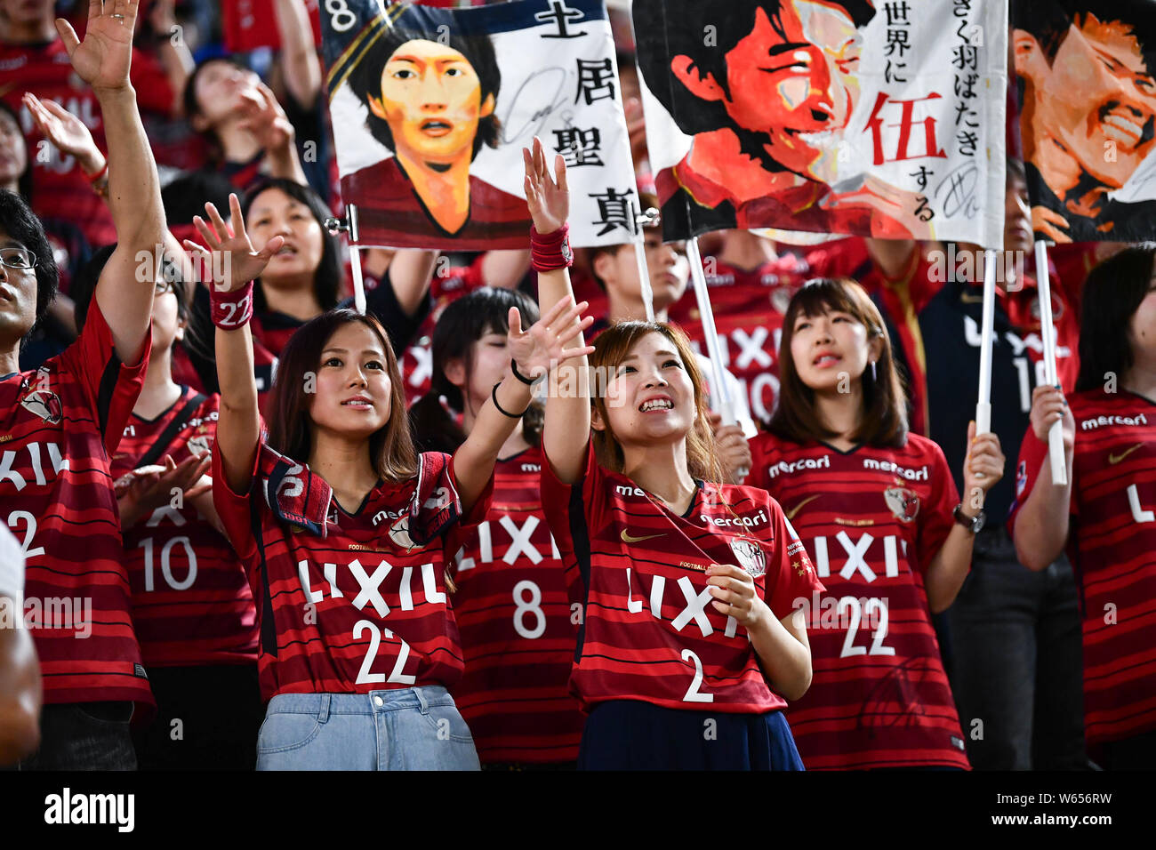 Football fans wave flags and shout slogans to show support for Japan's ...