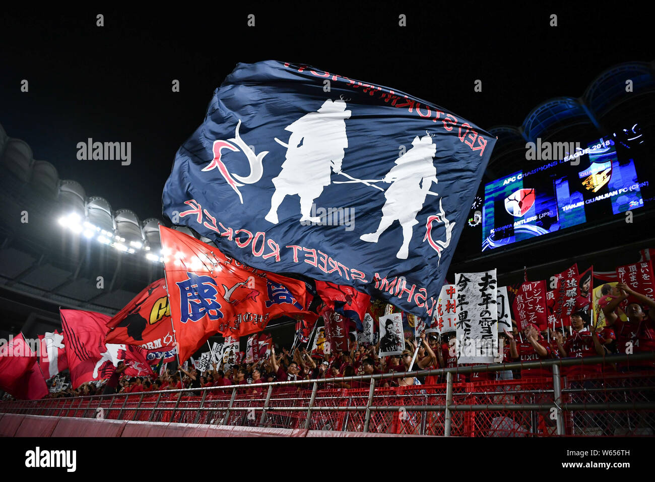 Football fans wave flags and shout slogans to show support for Japan's ...