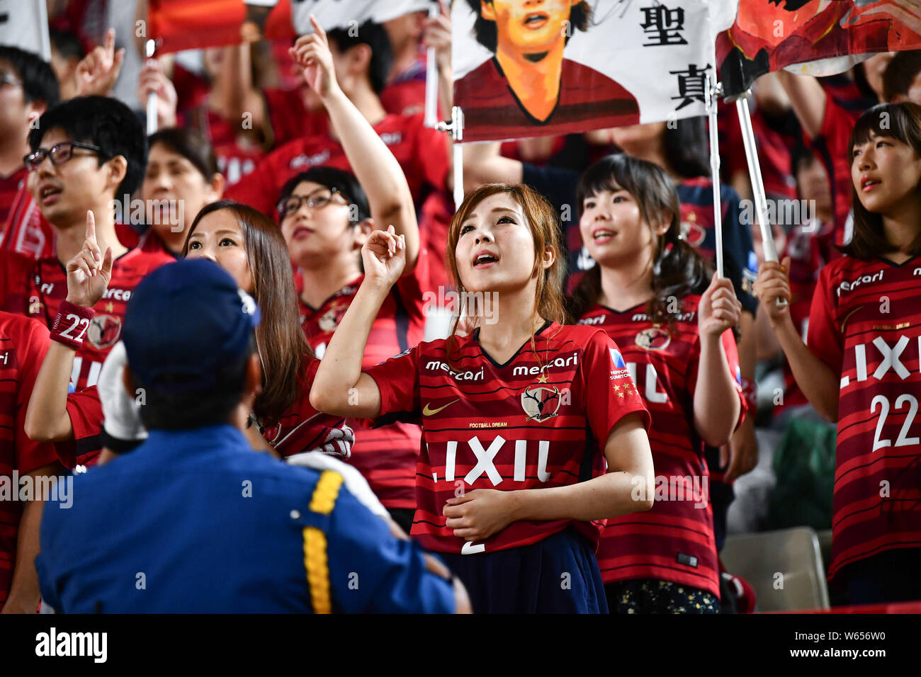 Football fans wave flags and shout slogans to show support for Japan's ...