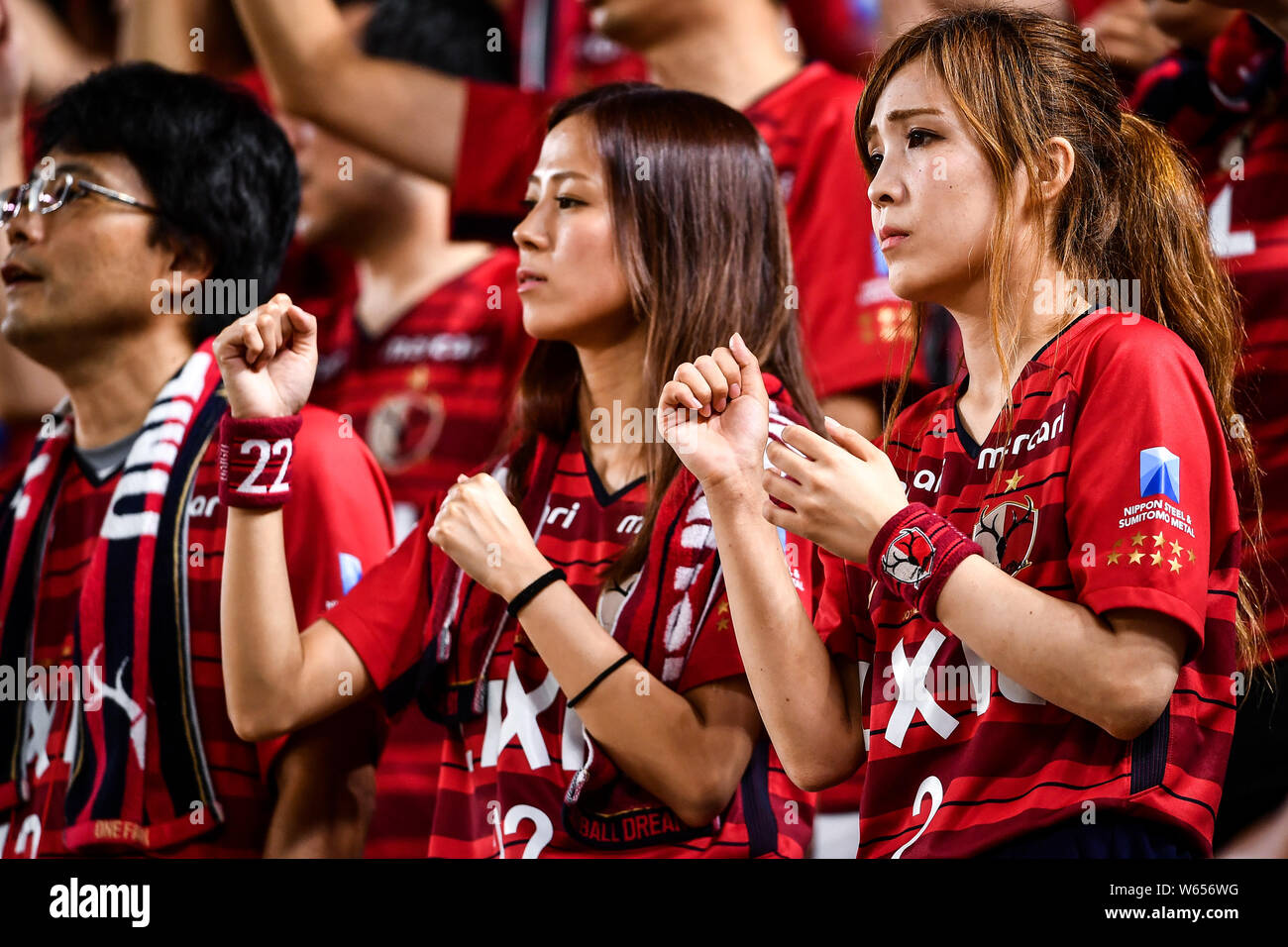 Football fans wave flags and shout slogans to show support for Japan's ...