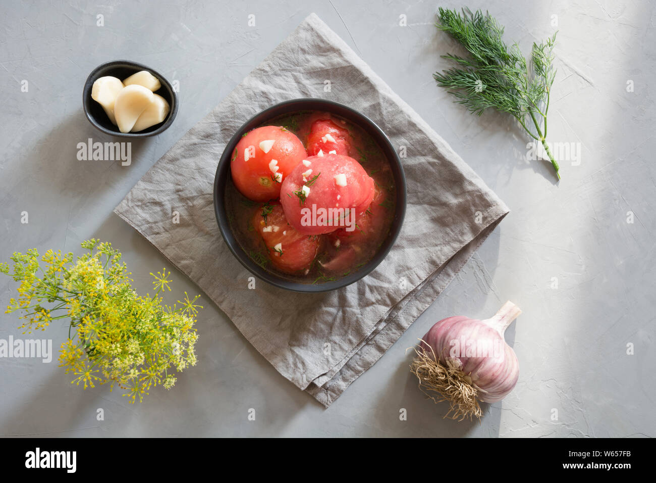Marinated peeled tomatoes with garlic and dill, fresh ready to serve ...