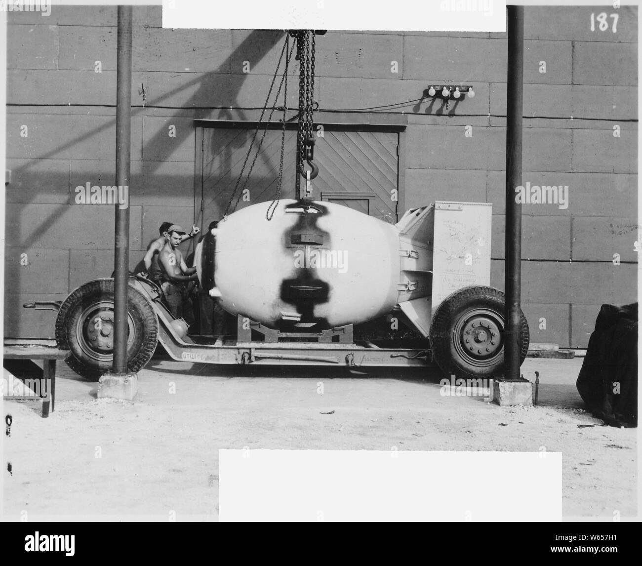 FM (Fat Man) unit being placed on trailer cradle in front of Assembly ...