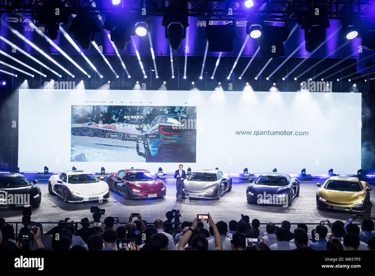 Lu Qun, Chairman of Qiantu Motor, delivers a speech during a launch ...
