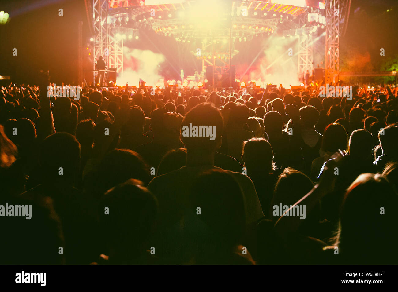Concert crowd watching rock band performance on the big stage. The ...