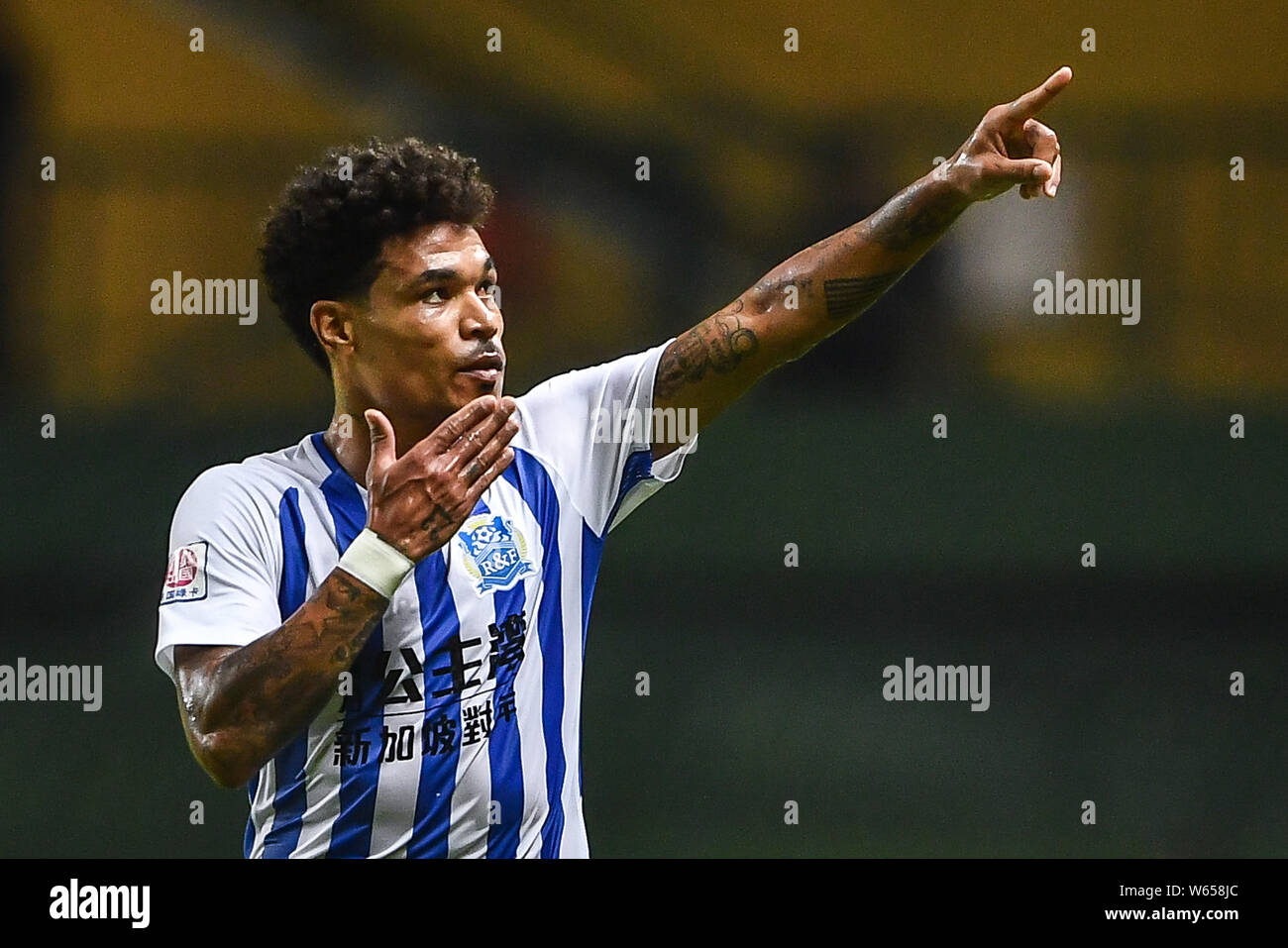 Brazilian football player Junior Urso of Guangzhou R&F celebrates after ...