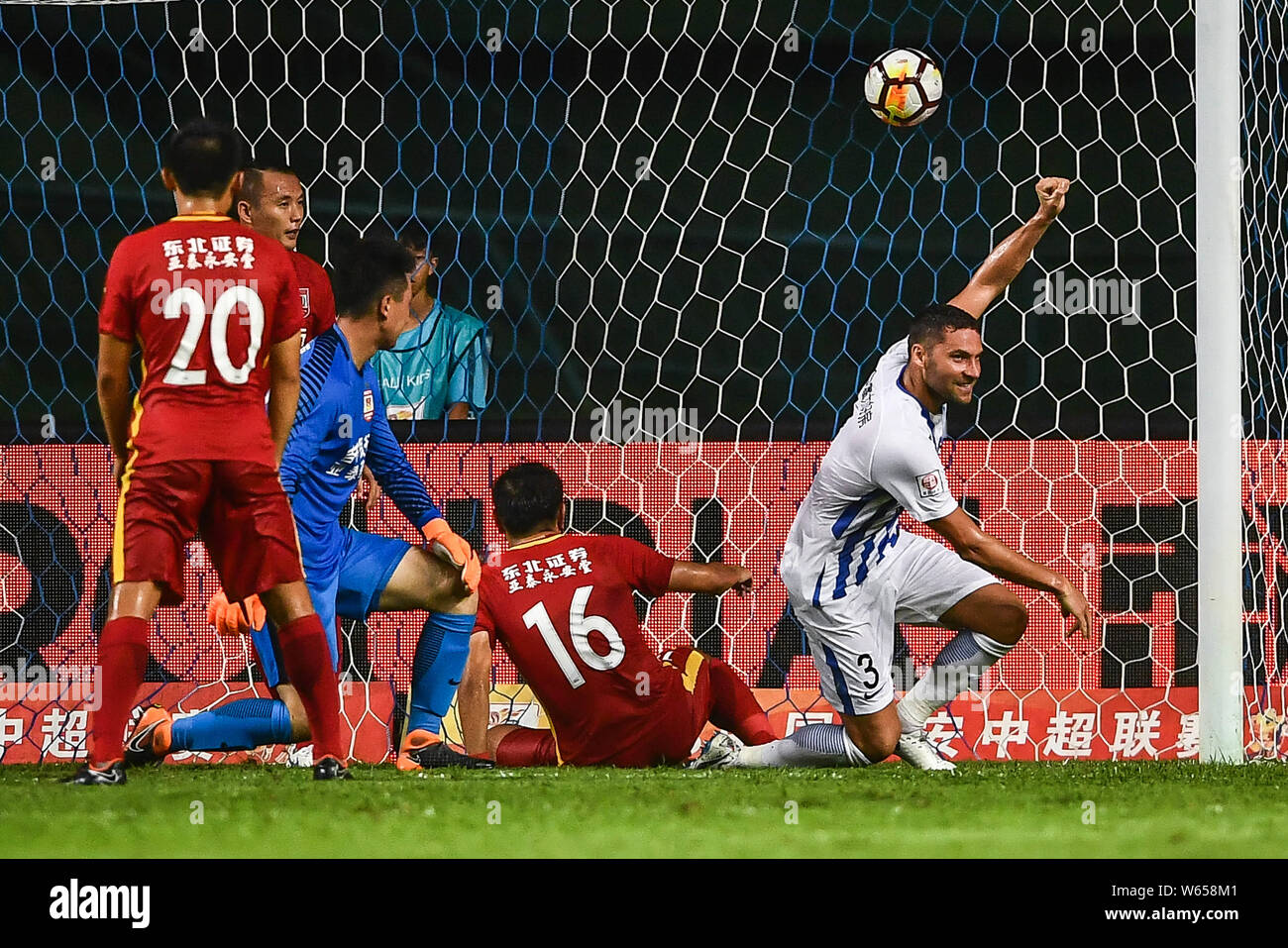 Serbian football player Dusko Tosic, right, of Guangzhou R&F celebrates ...