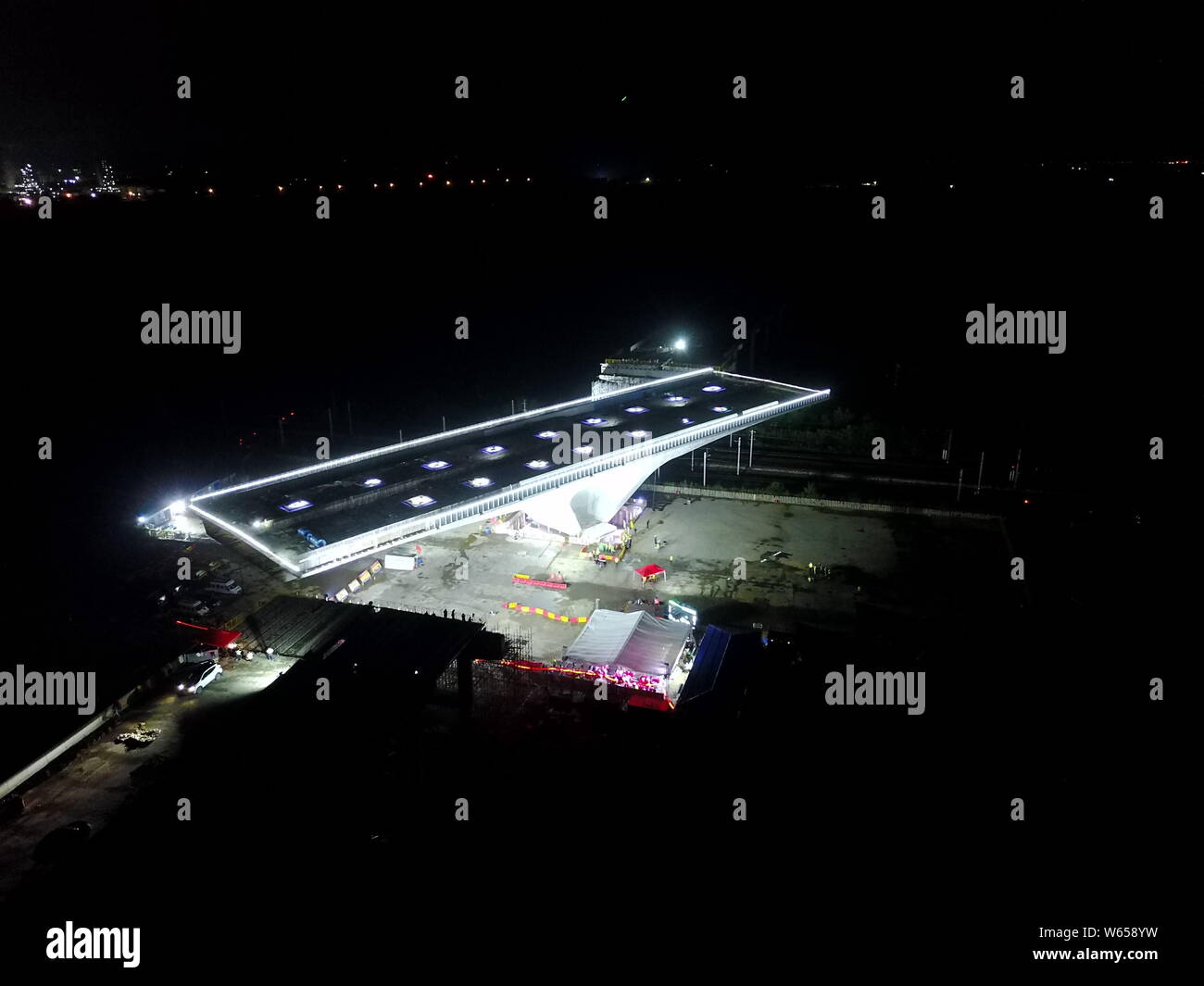 An 18,800-tonne box girder bridge is rotating 86.5 degrees ...