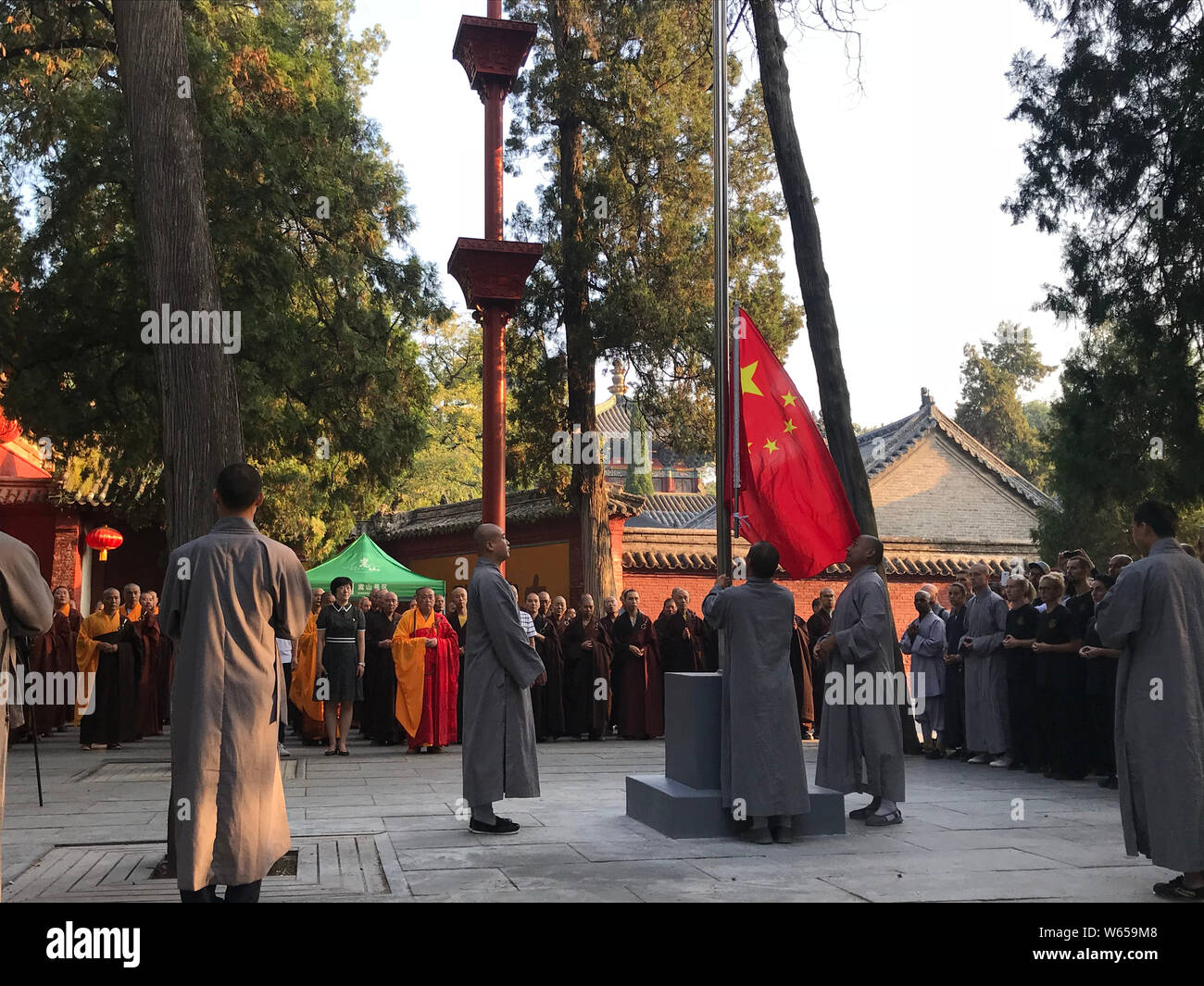 A Chinese national flag is raised during the flag-raising ceremony at ...