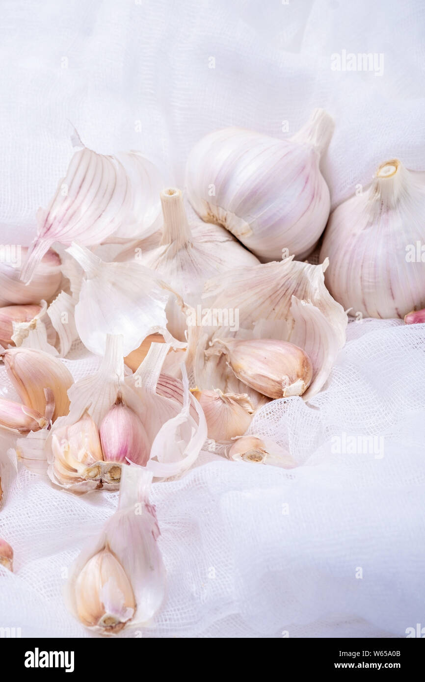 garlic, garlic cloves, garlic husks close-up on a white background with ...
