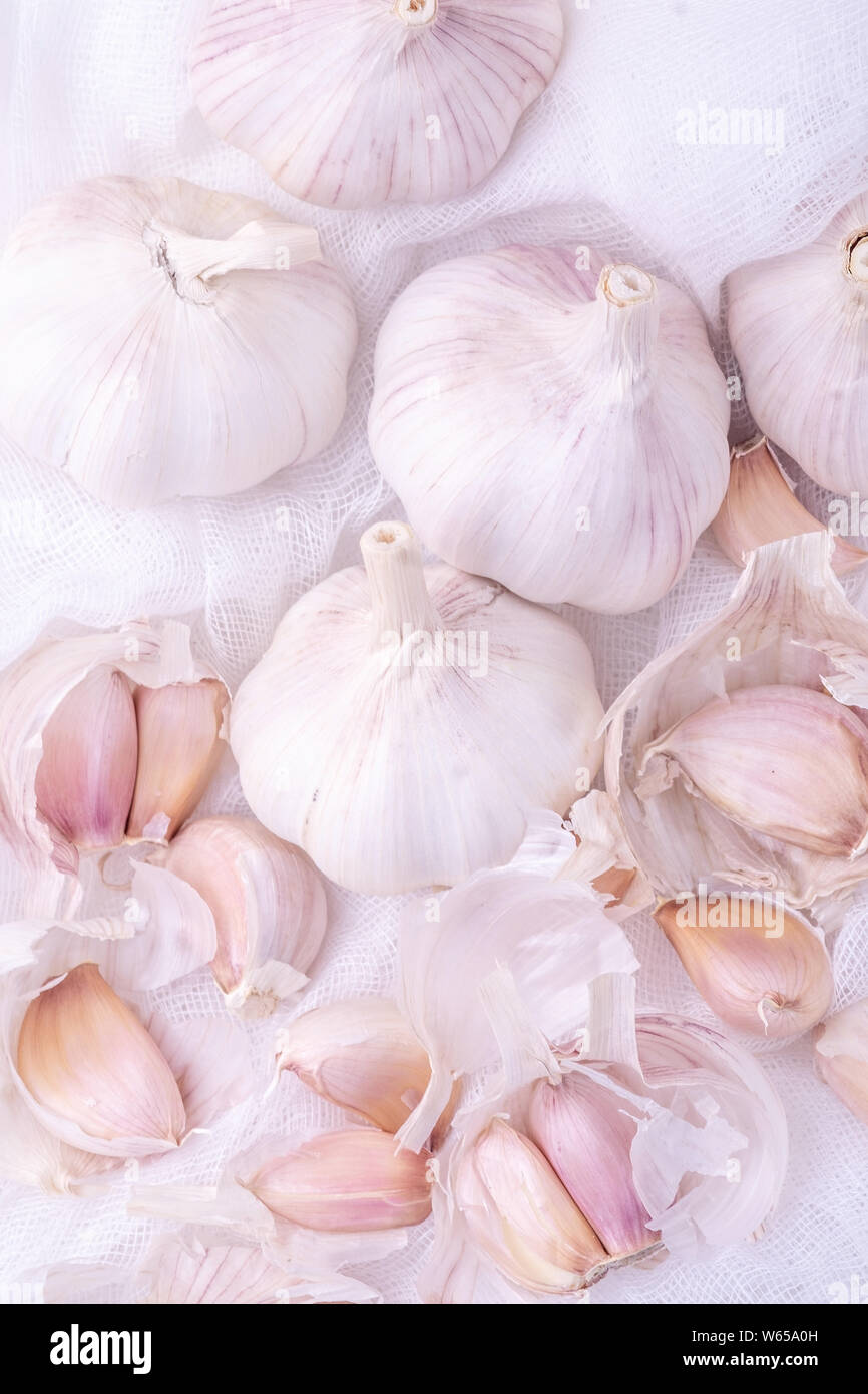 garlic, garlic cloves, garlic husks close-up on a white background with ...