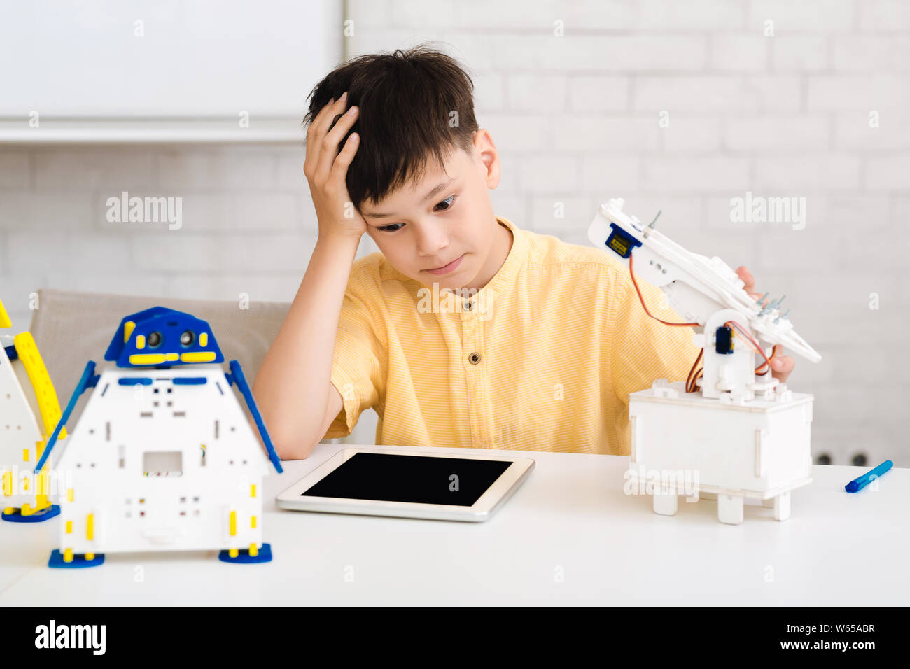 Stem education. Boy creating robot at lab Stock Photo - Alamy
