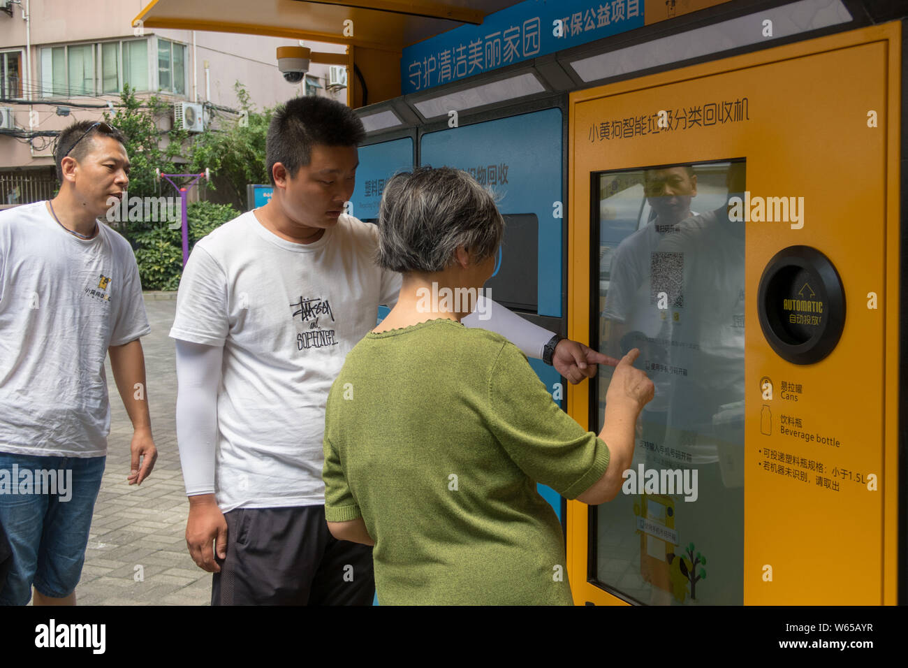 Local residents use a specially-designed sorting machine supported by ...