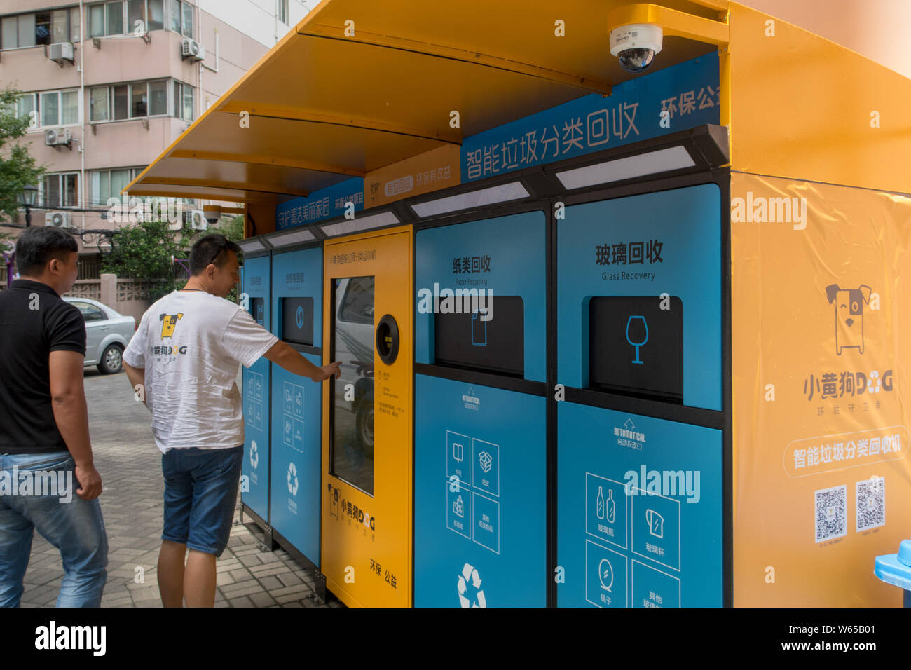 Local residents use a specially-designed sorting machine supported by ...