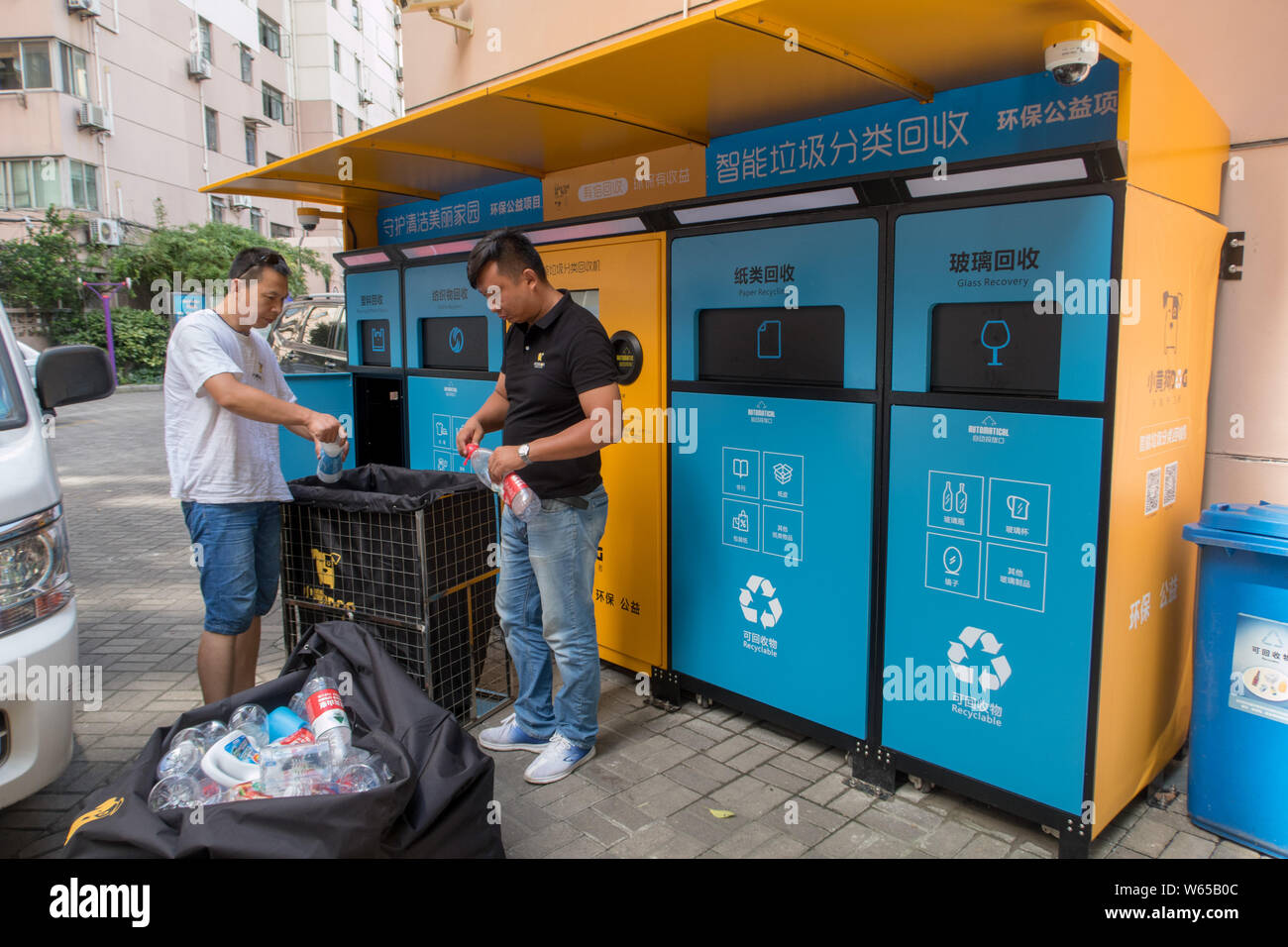 Local residents use a specially-designed sorting machine supported by ...