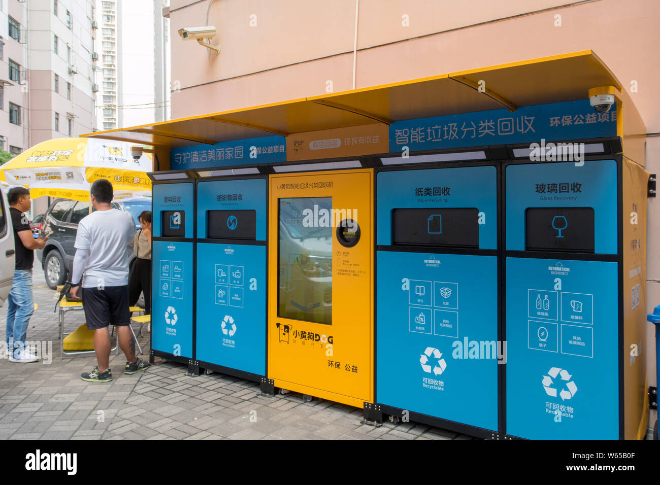 Local residents use a specially-designed sorting machine supported by ...