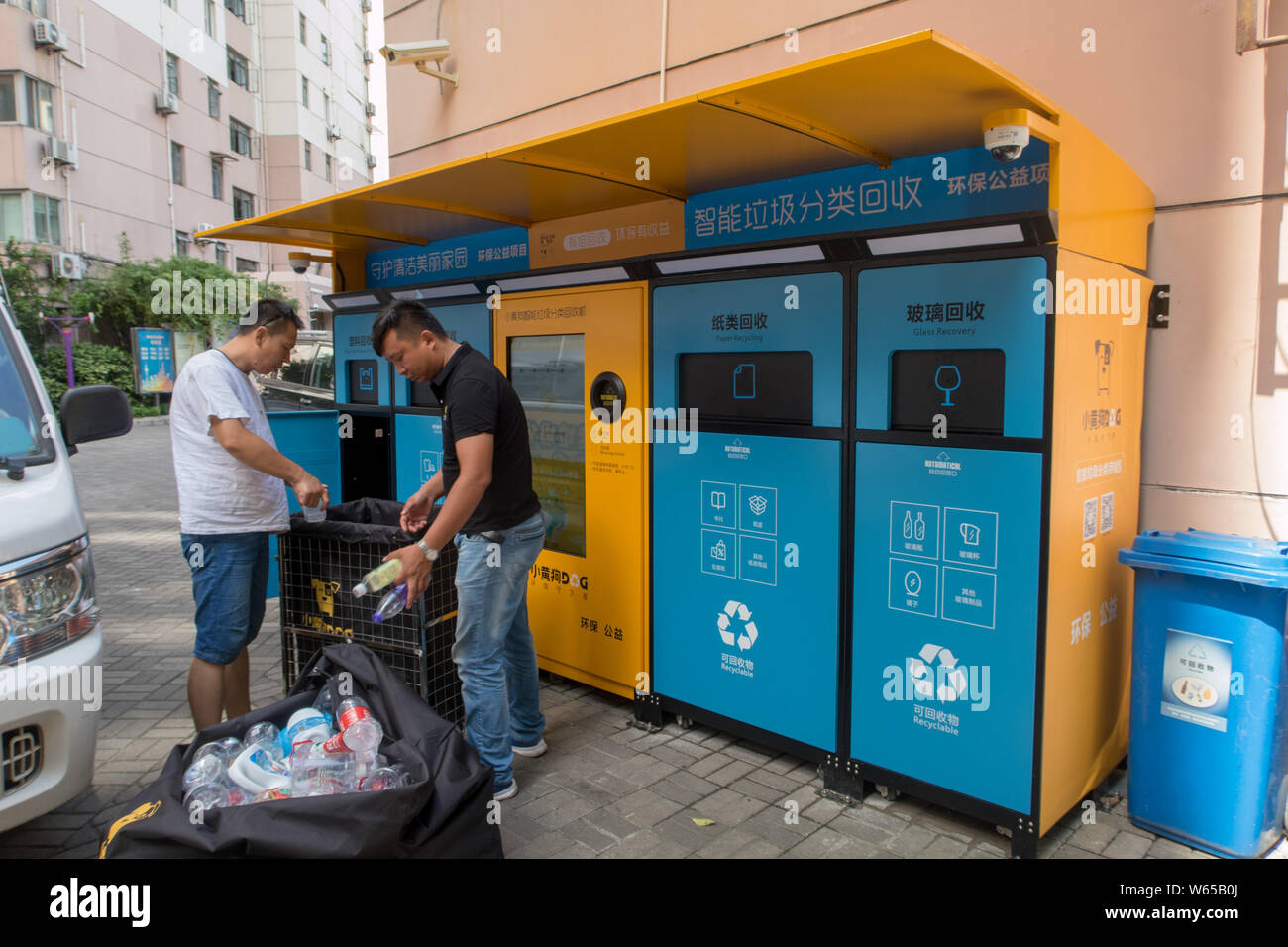 Local residents use a specially-designed sorting machine supported by ...
