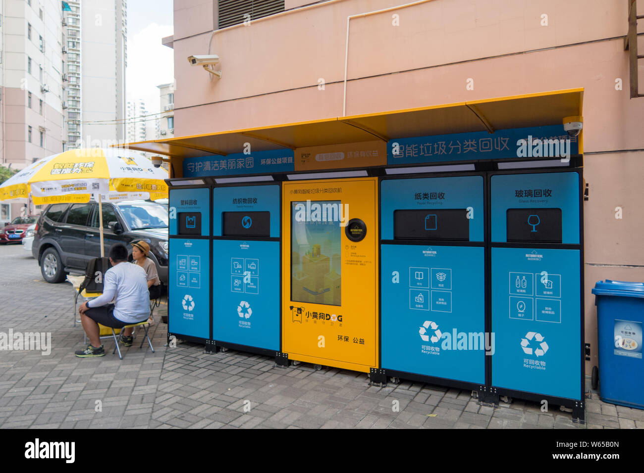 Local residents use a specially-designed sorting machine supported by ...